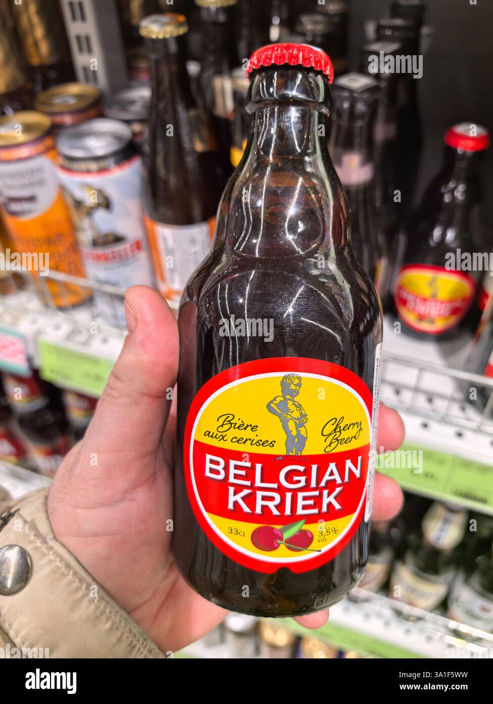 Bobruisk, Belarus - February 22, 2025: A hand holds a Belgian Kriek ...