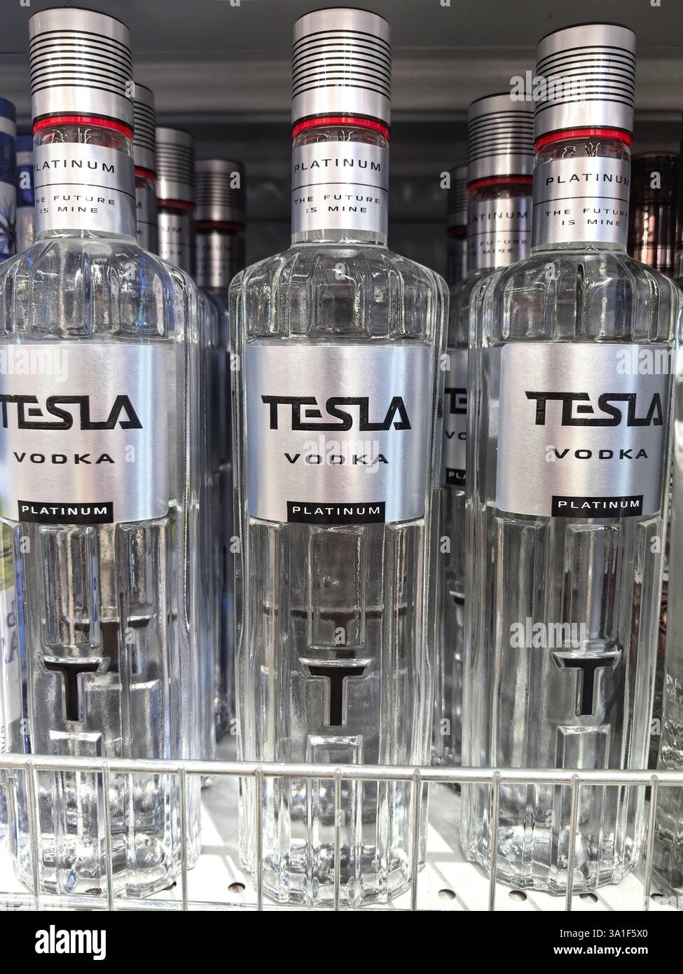 Bobruisk, Belarus - February 22, 2025: Three sleek vodka bottles Tesla ...