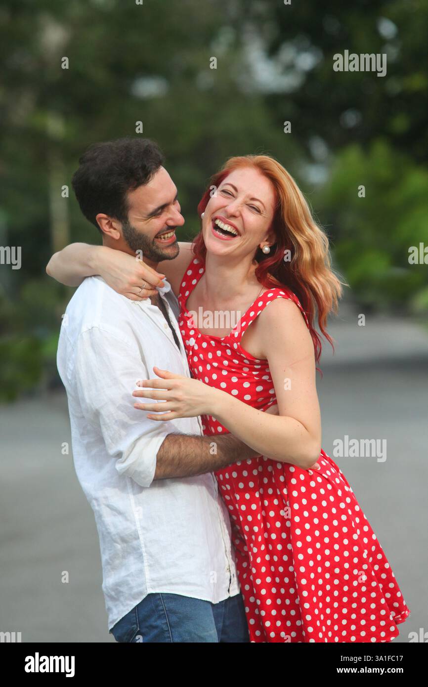 portrait of mid adult cheerful couple in love in the park on summer day ...