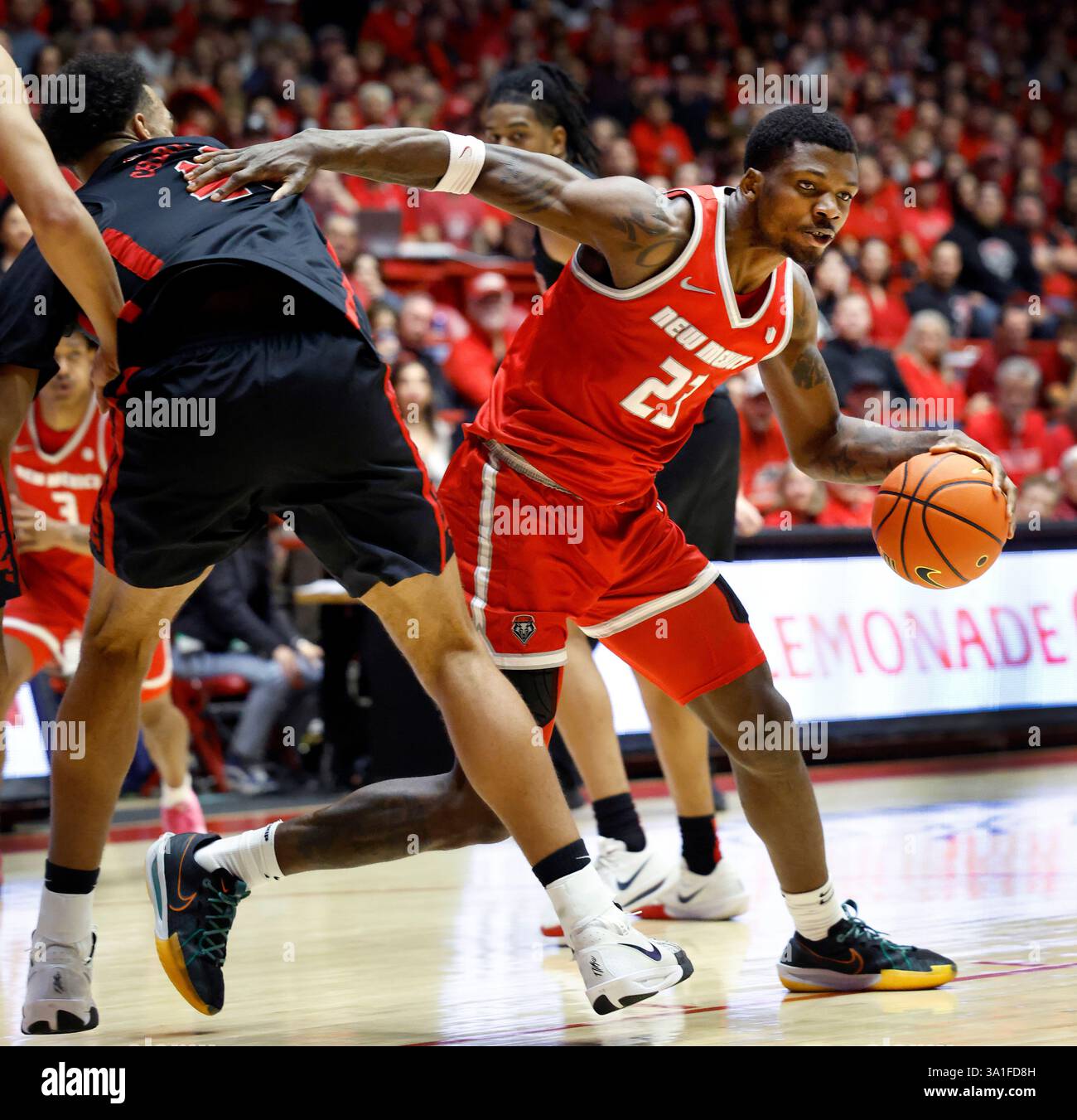 New Mexico center Nelly Junior Joseph drives around UNLV forward ...