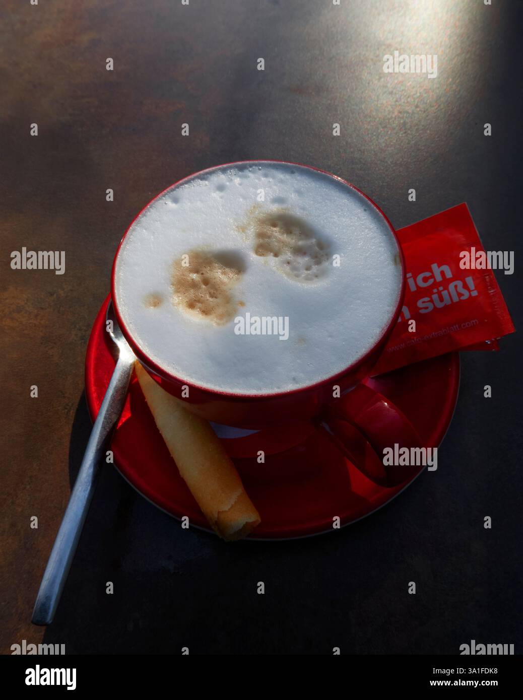 Cappuccino in a red cup,The photograph captures a red coffee cup filled ...