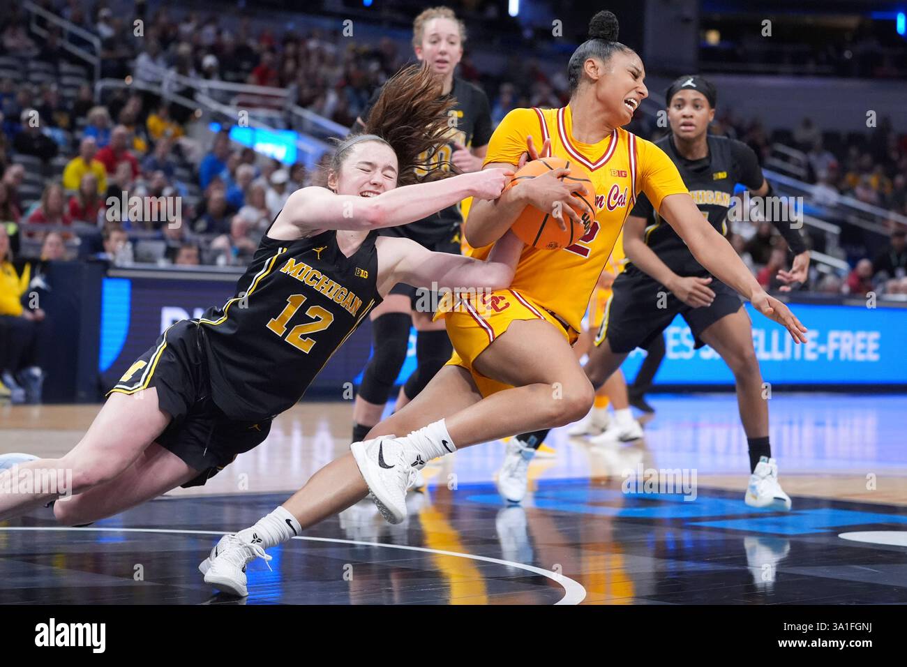 Michigan guard Syla Swords (12) fouls Southern California guard JuJu ...