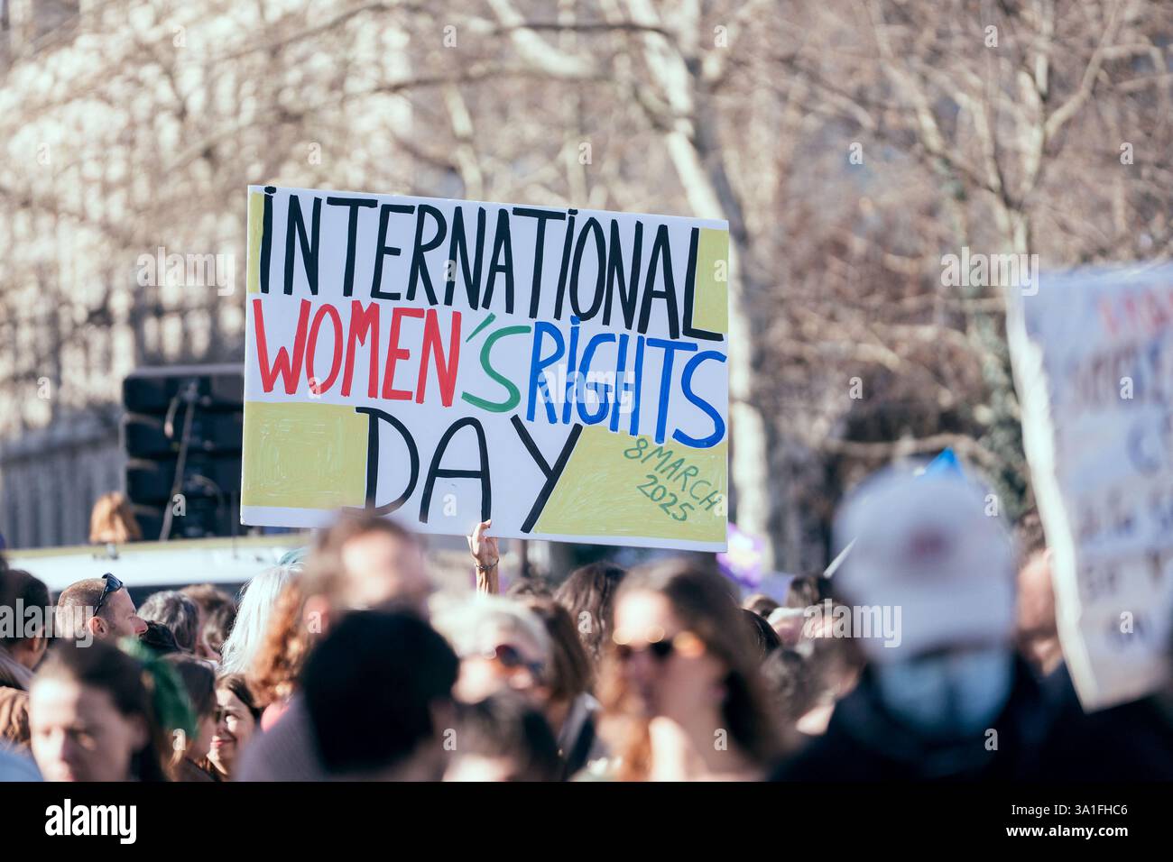 Paris, France. 08th Mar, 2025. A protester holds a placard reading ...