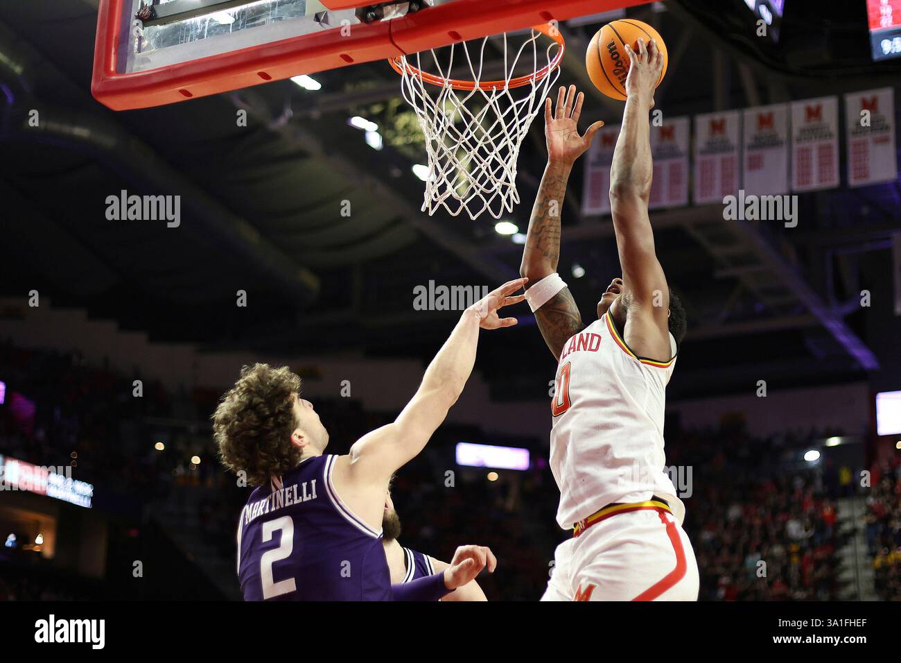 Maryland forward Julian Reese (10) takes a shot over Northwestern forward Nick Martinelli (2 ...