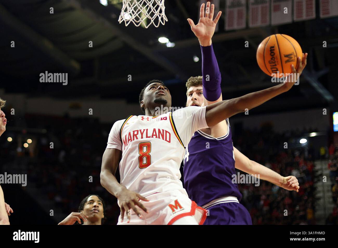 Maryland guard Jay Young (8) takes a shot over Northwestern center ...