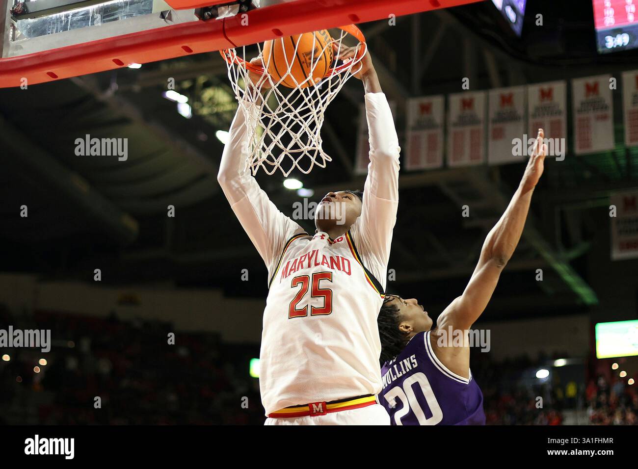 Maryland center Derik Queen (25) dunks over Northwestern guard Justin ...