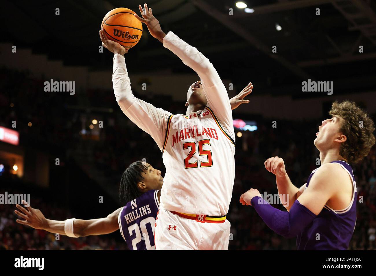 Maryland center Derik Queen (25) takes a shot over Northwestern guard ...