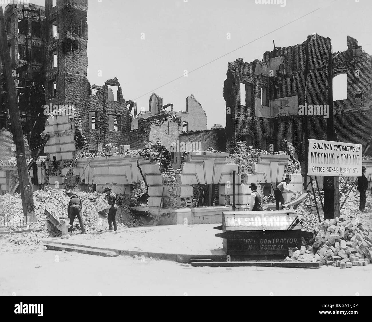 Damaged buildings after earthquake with sign for Sullivan Contracting ...