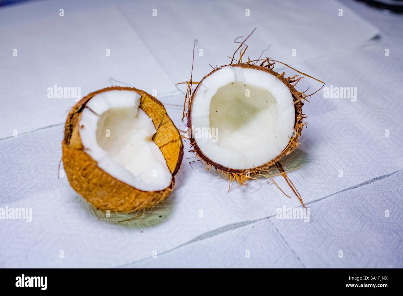 Coconut cut in halfs Stock Photo - Alamy