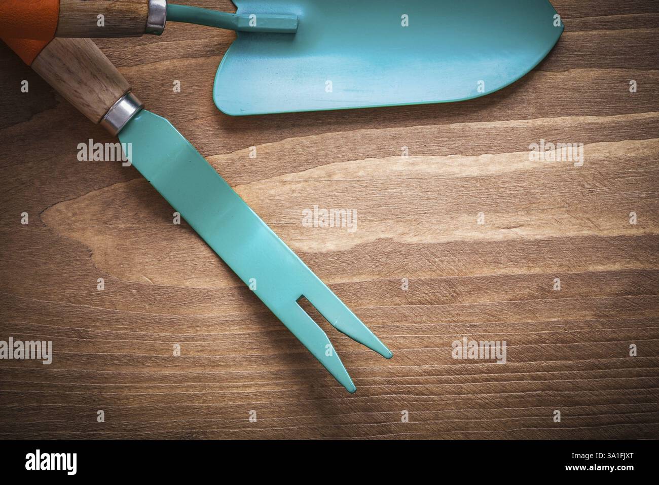Metal weeding scoop hand spade on wood board agriculture concept Stock ...