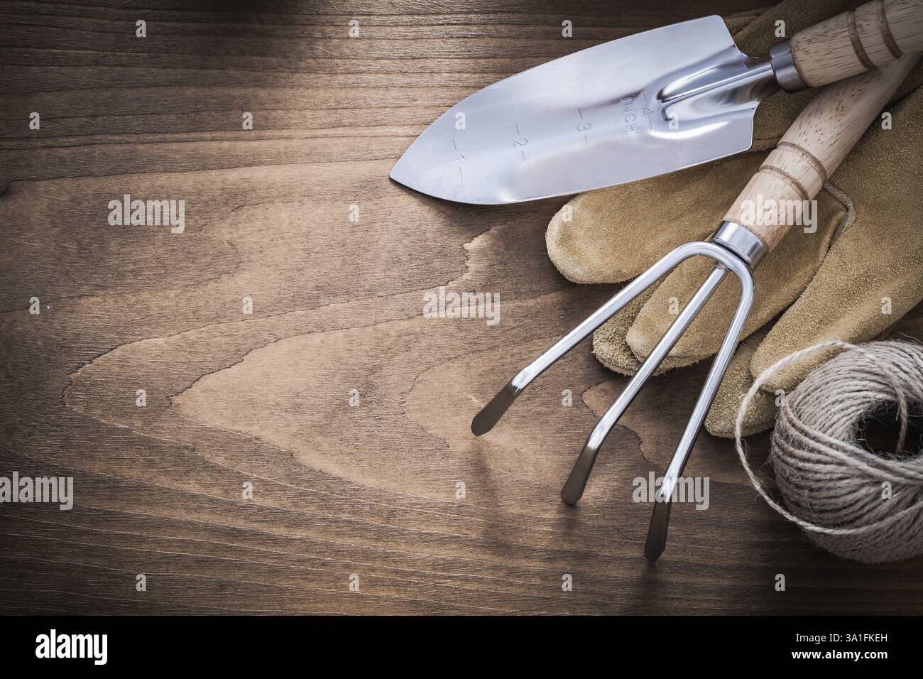 Metal hand spade rake brown leather gardening gloves and hank of string ...