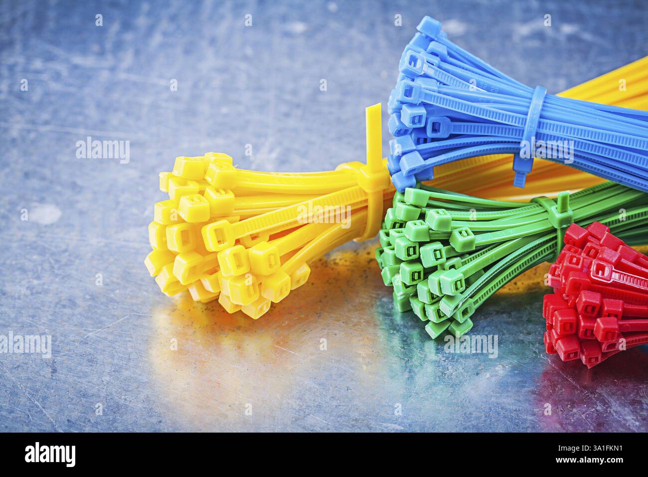 Multicolored plastic zip cable ties on metallic background construction ...