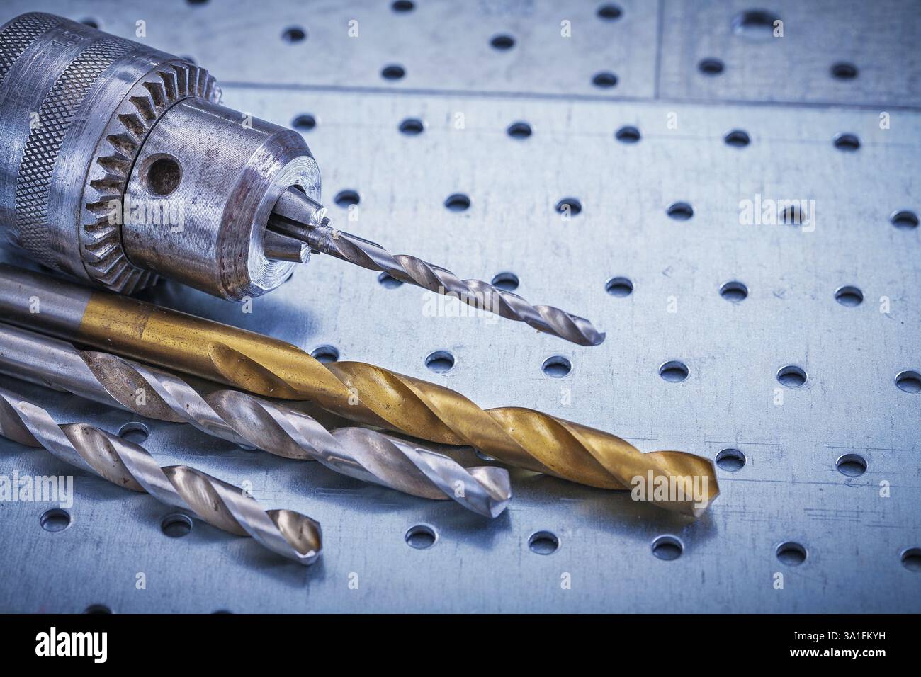 Metal drill with boring bits on perforated metallic sheet construction ...