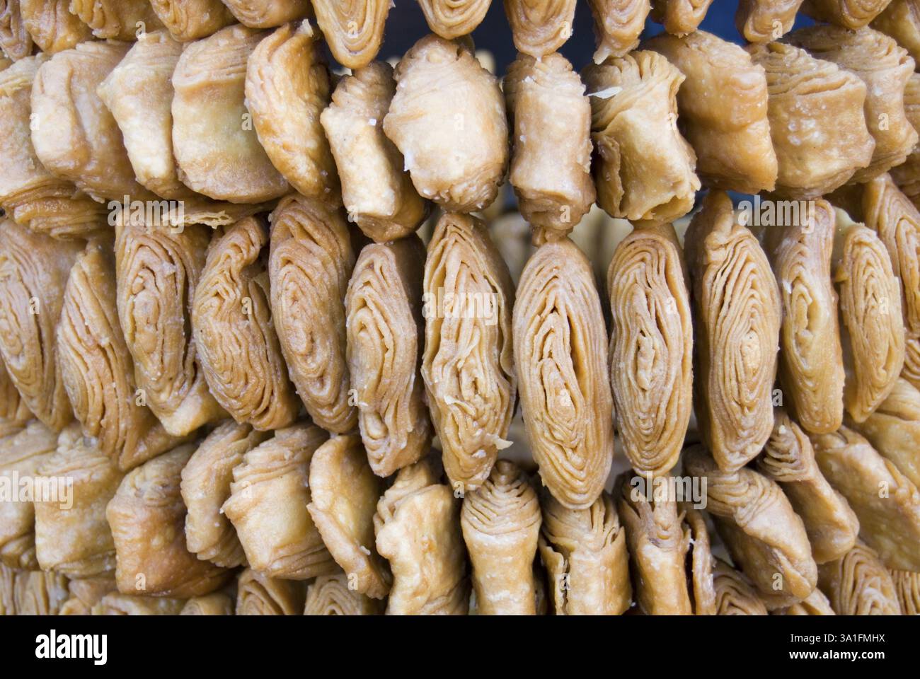 Traditional sweets stringed together offerings to god Jagannath at shop ...