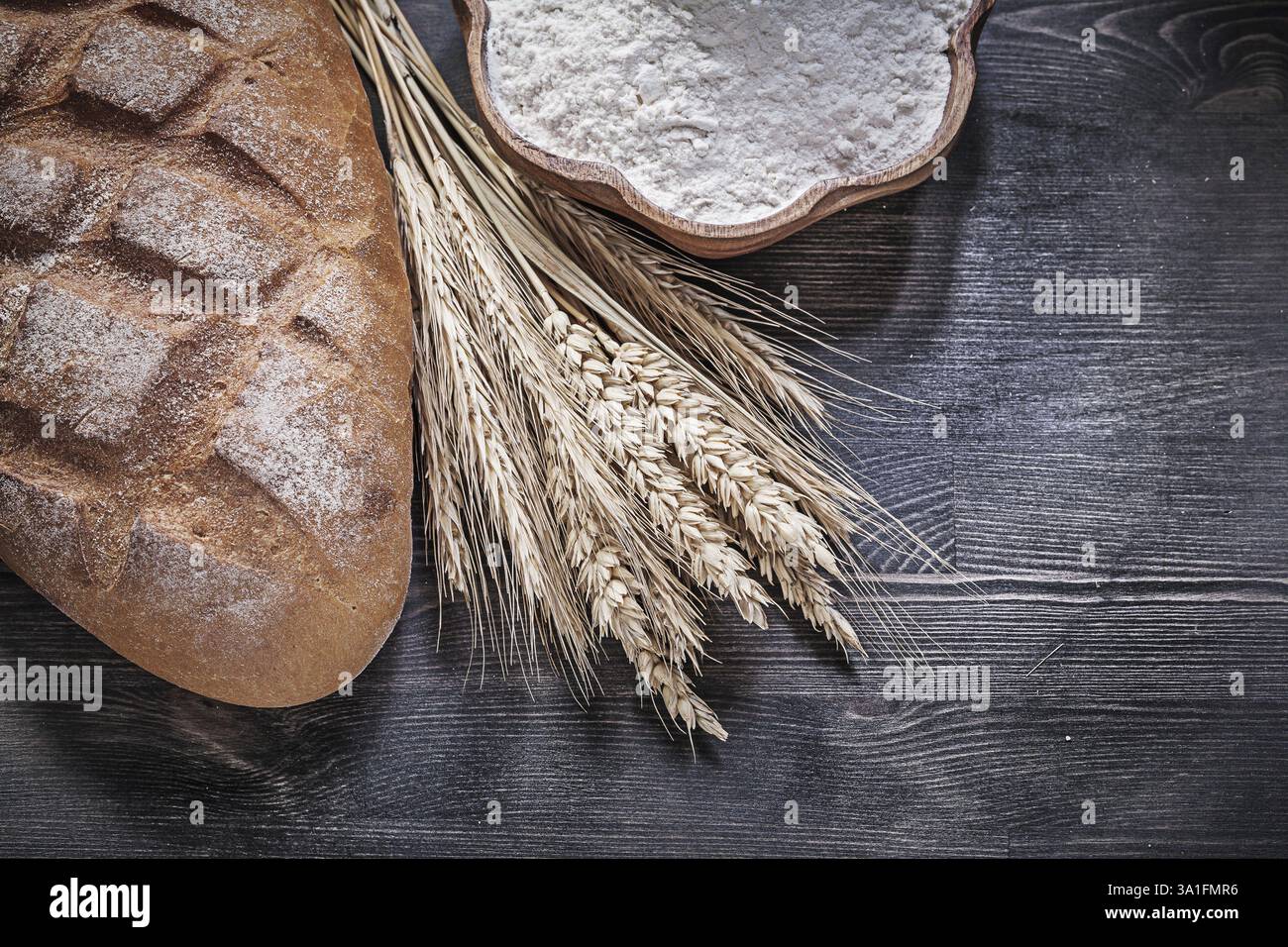 Loaf of brown bread wheat rye ears wooden bowl with flour on wood board Stock Photo - Alamy