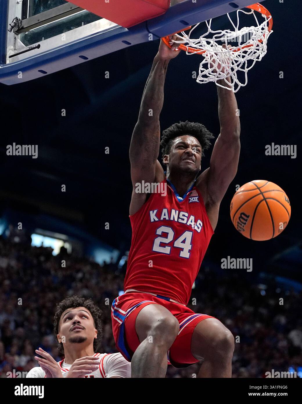 Kansas forward KJ Adams Jr. (24) dunks the ball during the first half ...