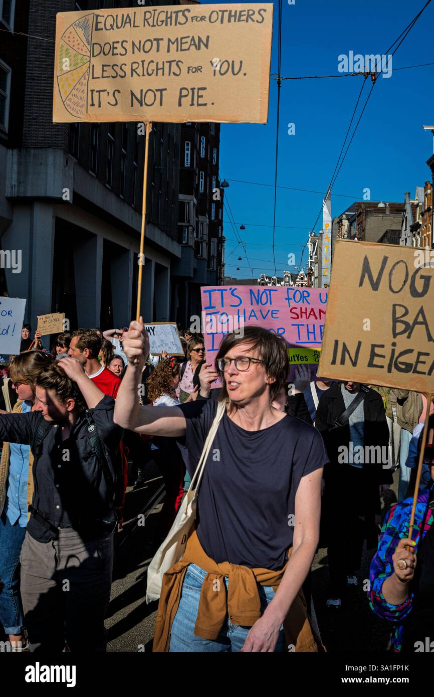 Amsterdam, North Holland, Netherlands. 8th Mar, 2025. A marcher holds a ...