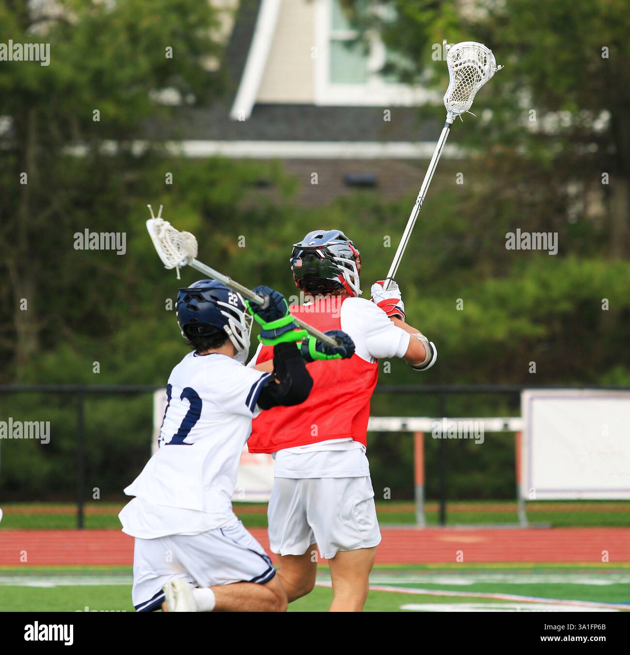 Two lacrosse players practice together, focusing on skill development ...