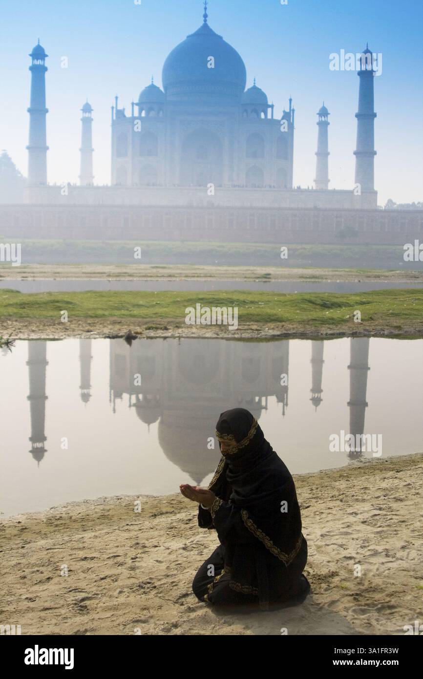 A Muslim woman offering namaz in front of mogul monument Taj Mahal ...