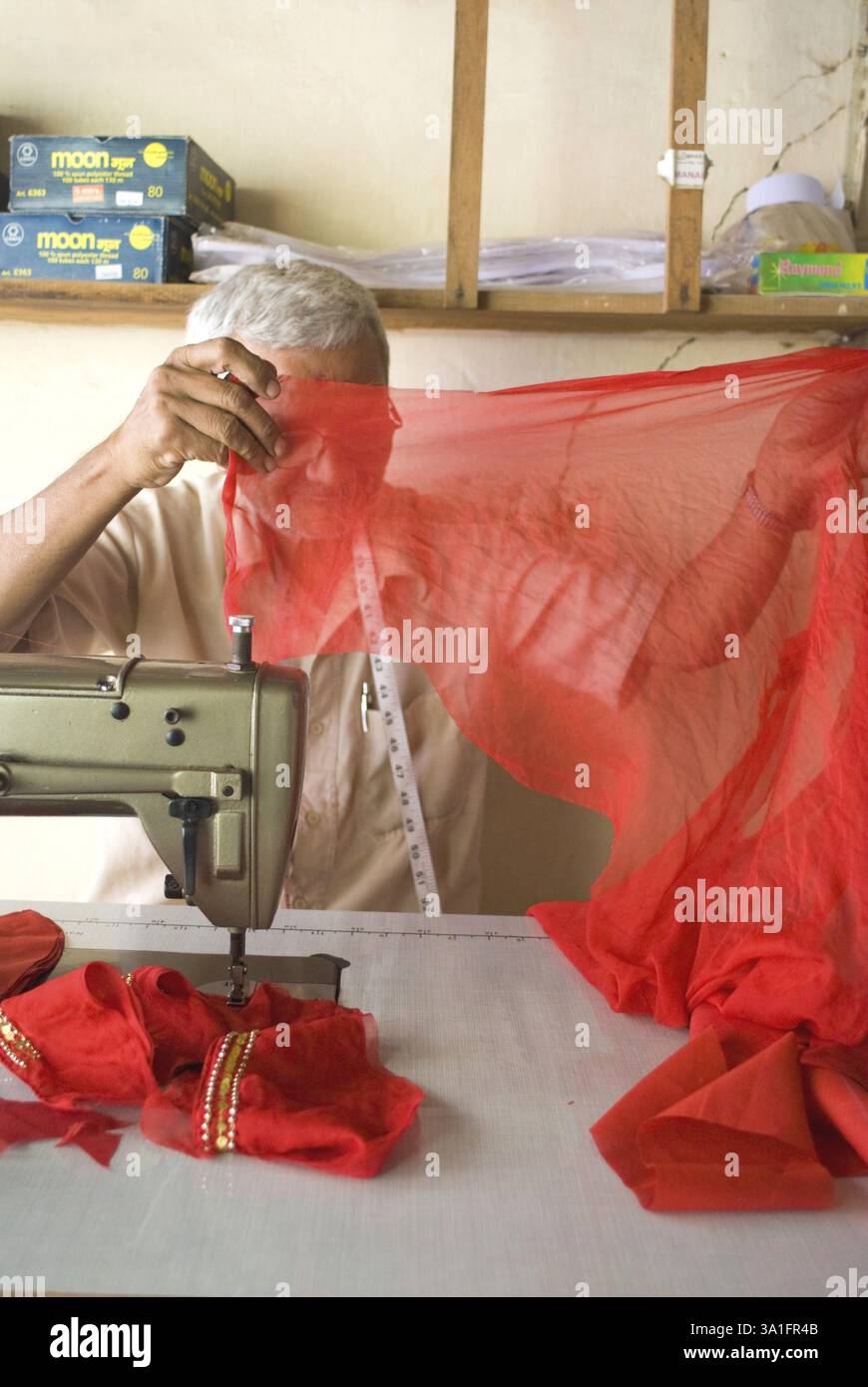 Tailor stitching red cloth on sewing machine, Anjar, Kutch, Gujarat ...