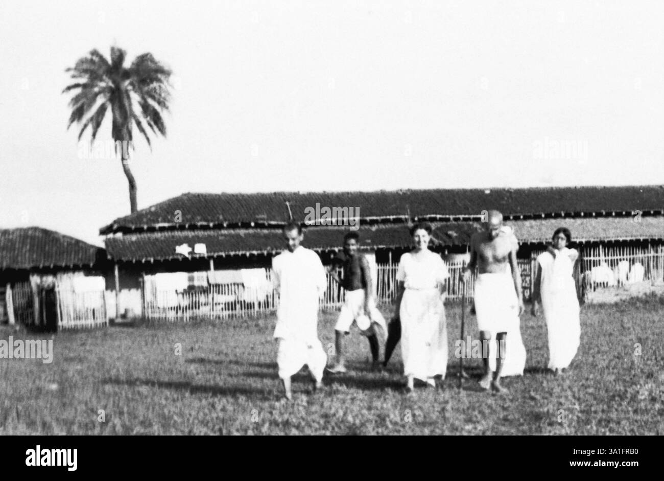 Mahatma Gandhi walking with Hanna Lazar and others on the compound of ...