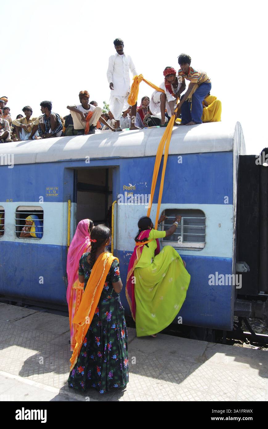 Men dragging woman by turban on roof of train on railway station ...
