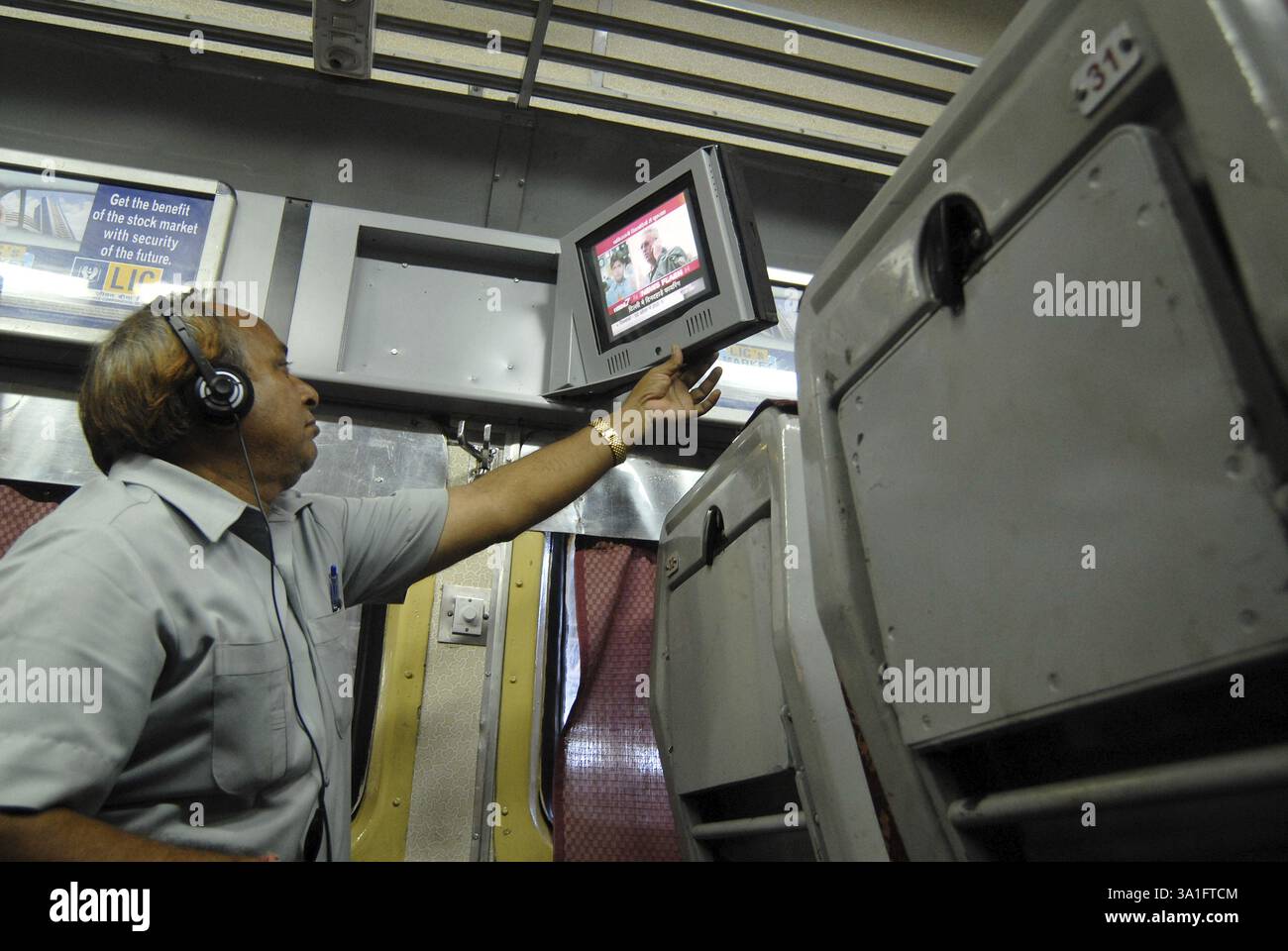 Passenger watching television introduce by Indian Railways on experimental basis in one of air ...