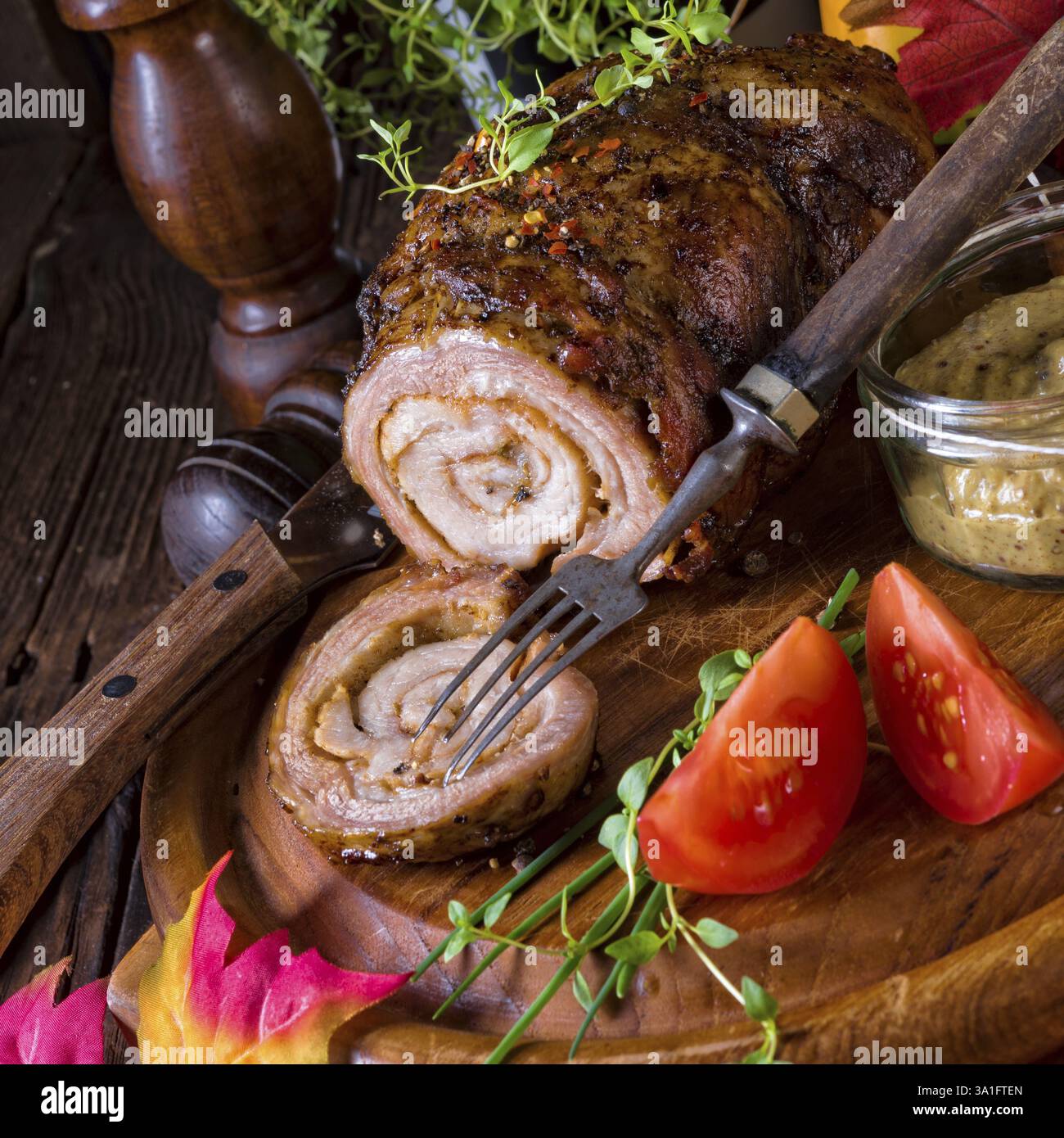 Rolling roasts fullly with dried fruit and bacon Stock Photo - Alamy