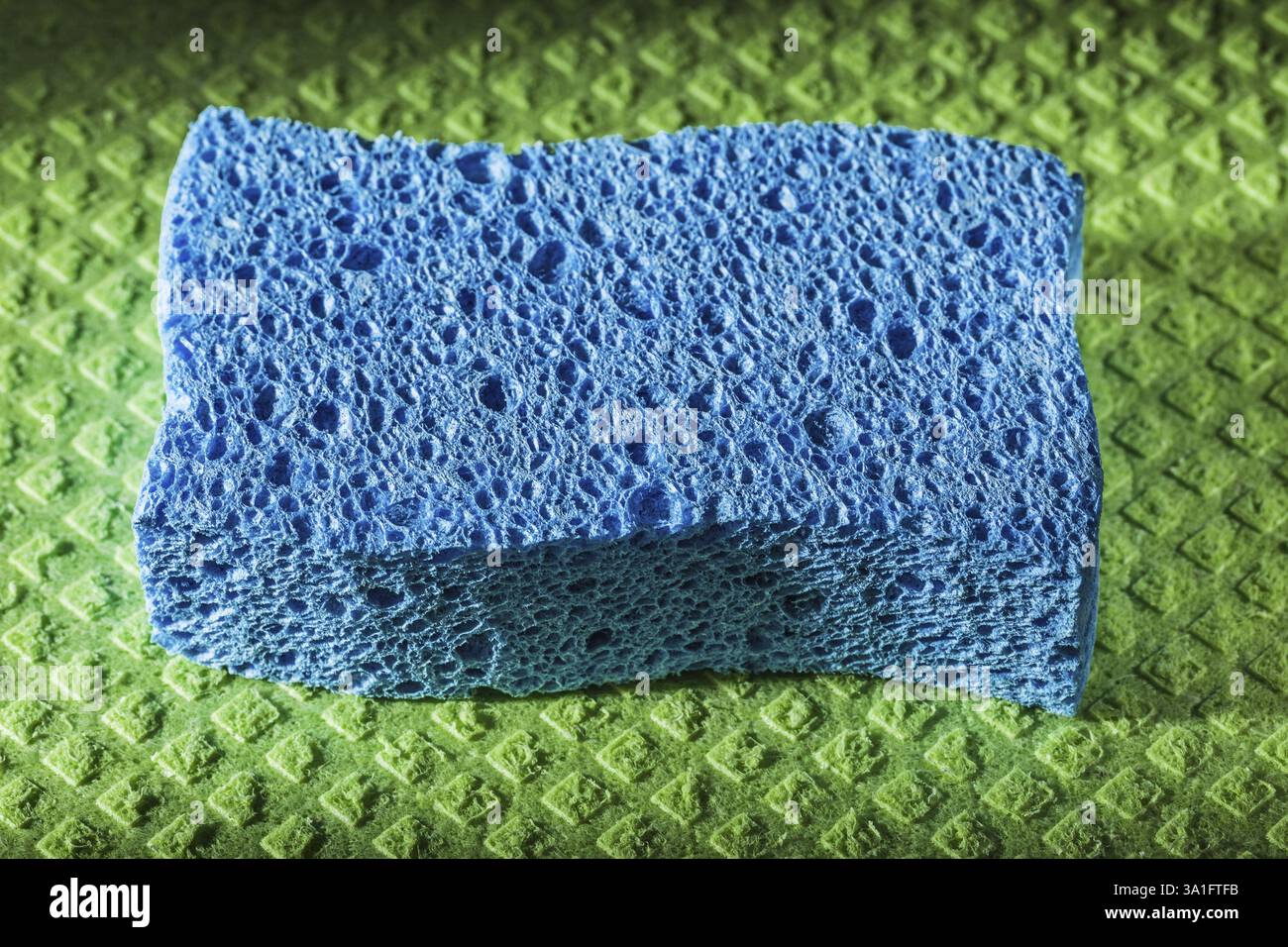 New blue sponge on dishcloth Stock Photo - Alamy