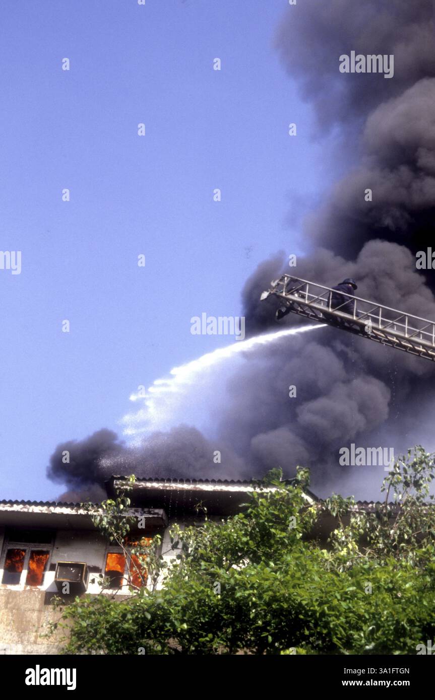The fire fighters trying to douse the fire which broke in the Khatau ...