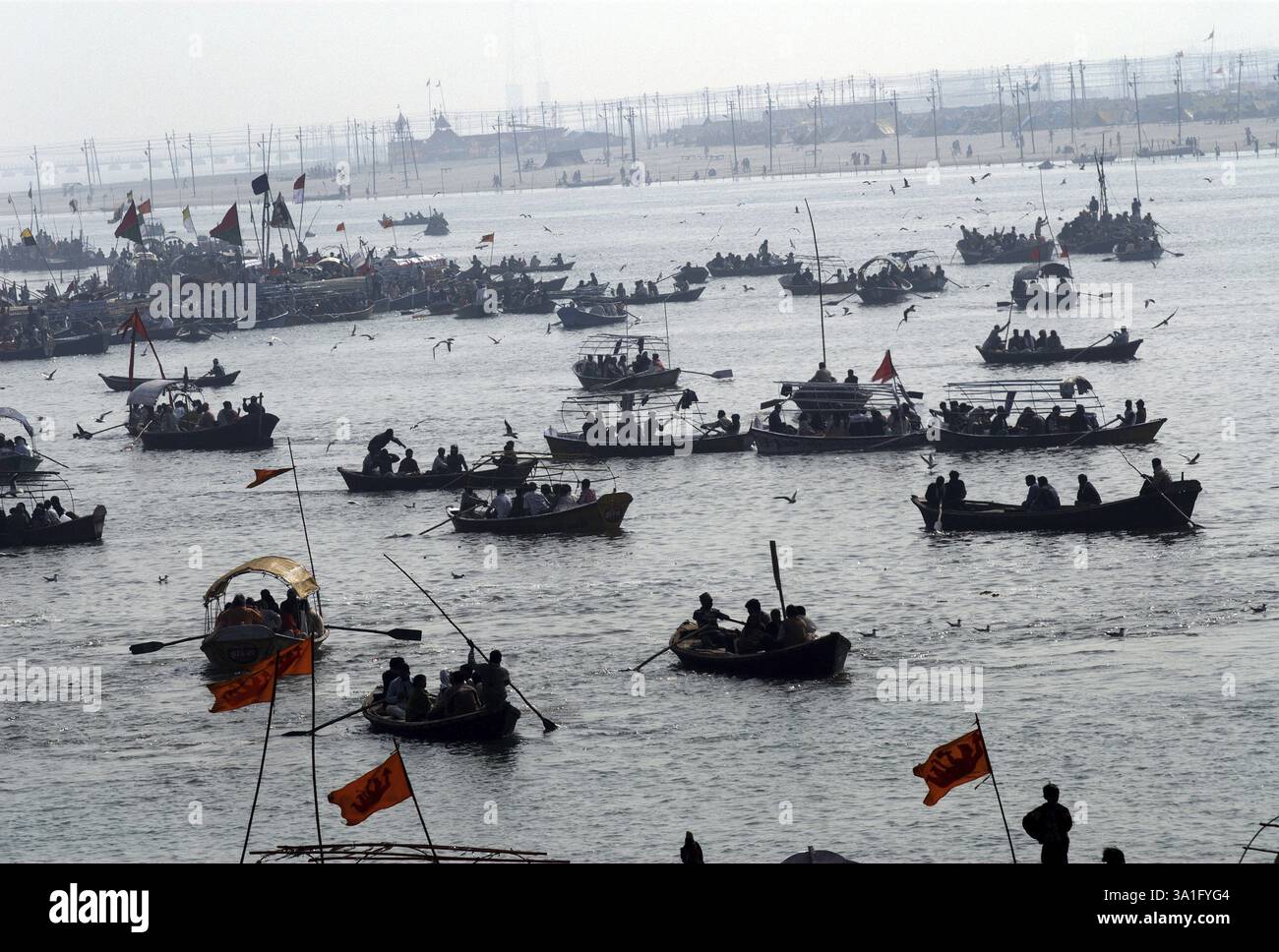 Boats or ferries ferry devotees at the confluence of the Ganges, Yamuna ...