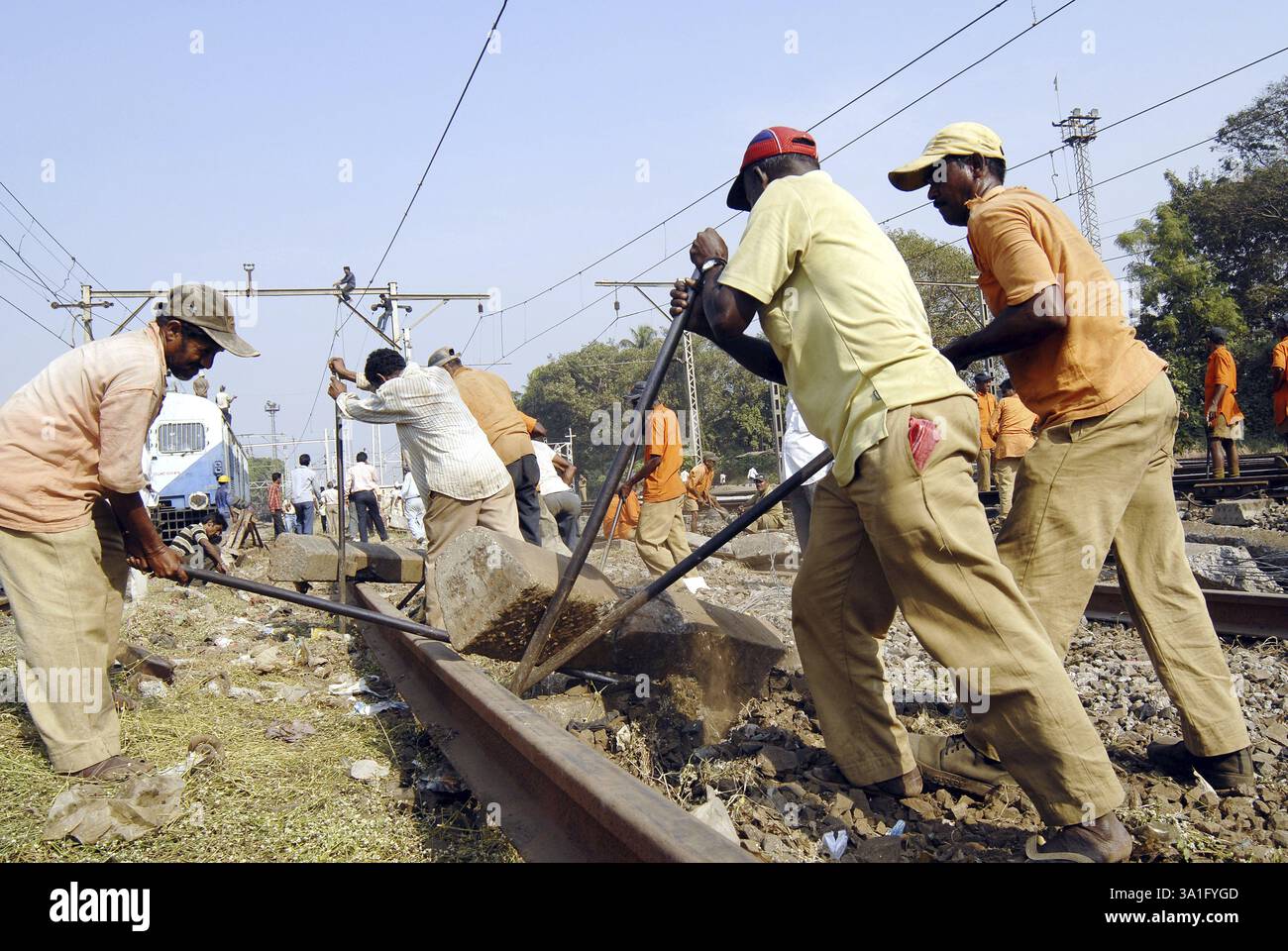 Railway workers repair damaged railway tracks after local derailed ...