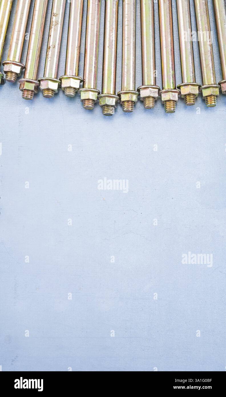Metal anchor bolts for concrete walls and nuts on metallic background ...