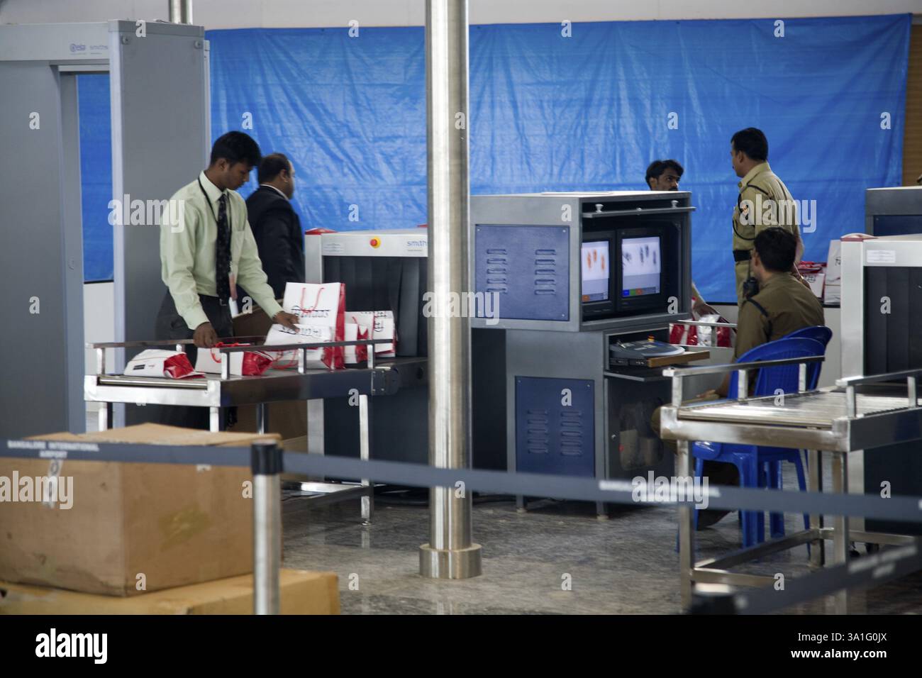 Security check, Duty officers scanning the baggage through monitors ...