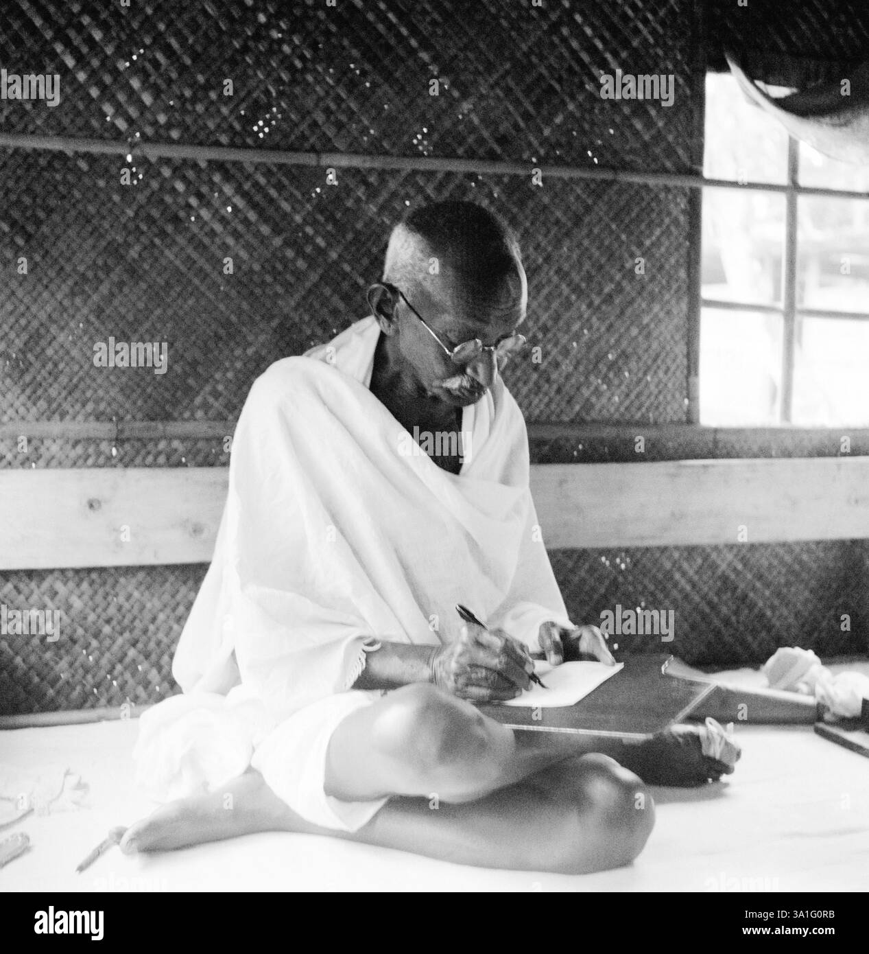 Mahatma Gandhi, sitting in his mobile hut at Noakhali East Bengal and ...