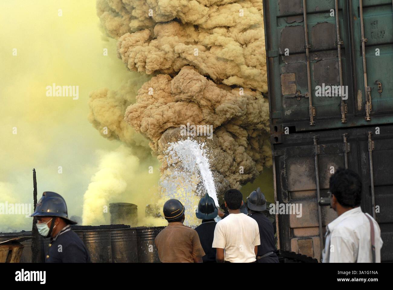 Fire brigade personnel or fire fighters trying to extinguish fire in ...