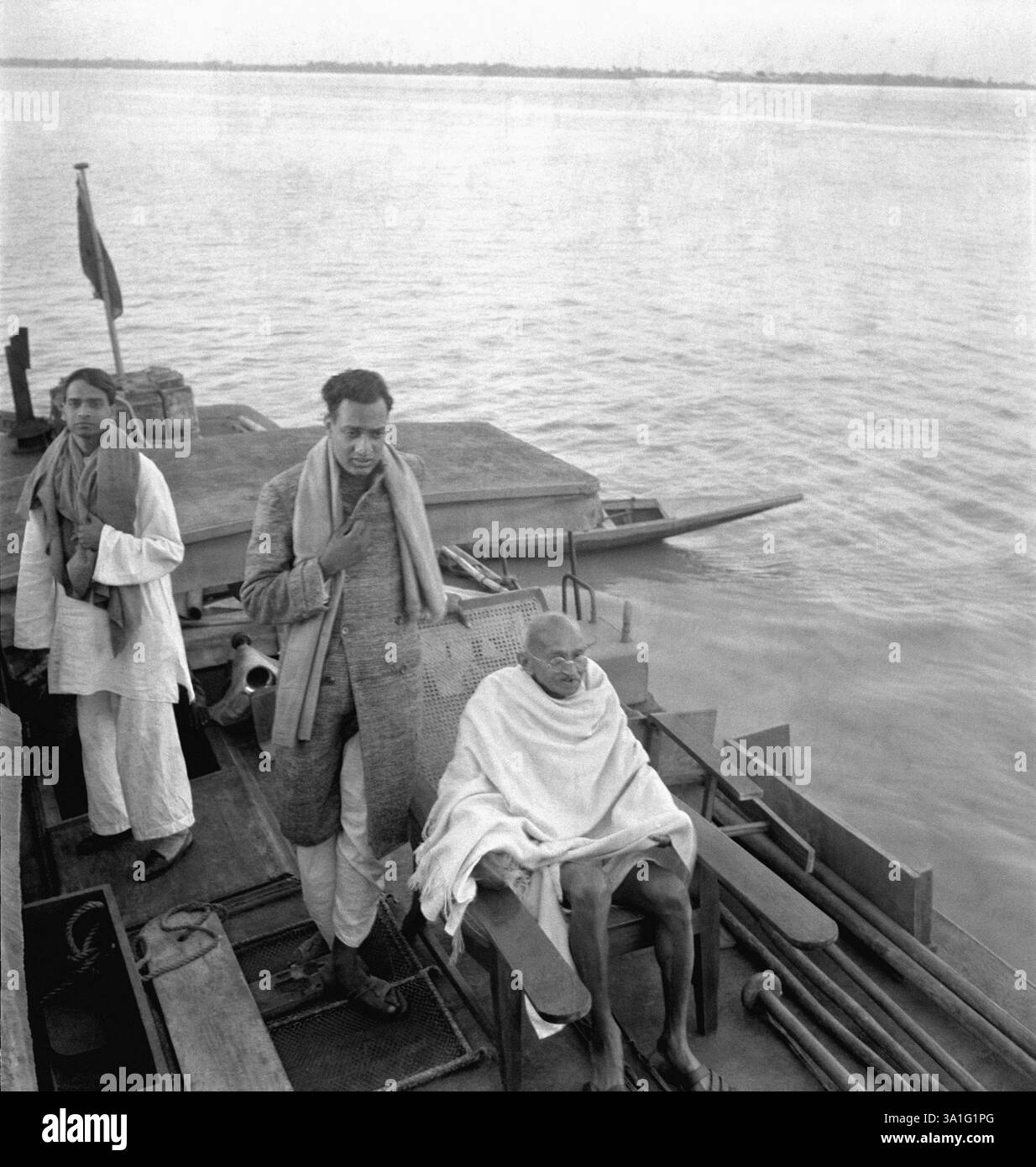 Sudhir Ghosh, Ramkrishna Bajaj and Mahatma Gandhi on a boat on the way ...