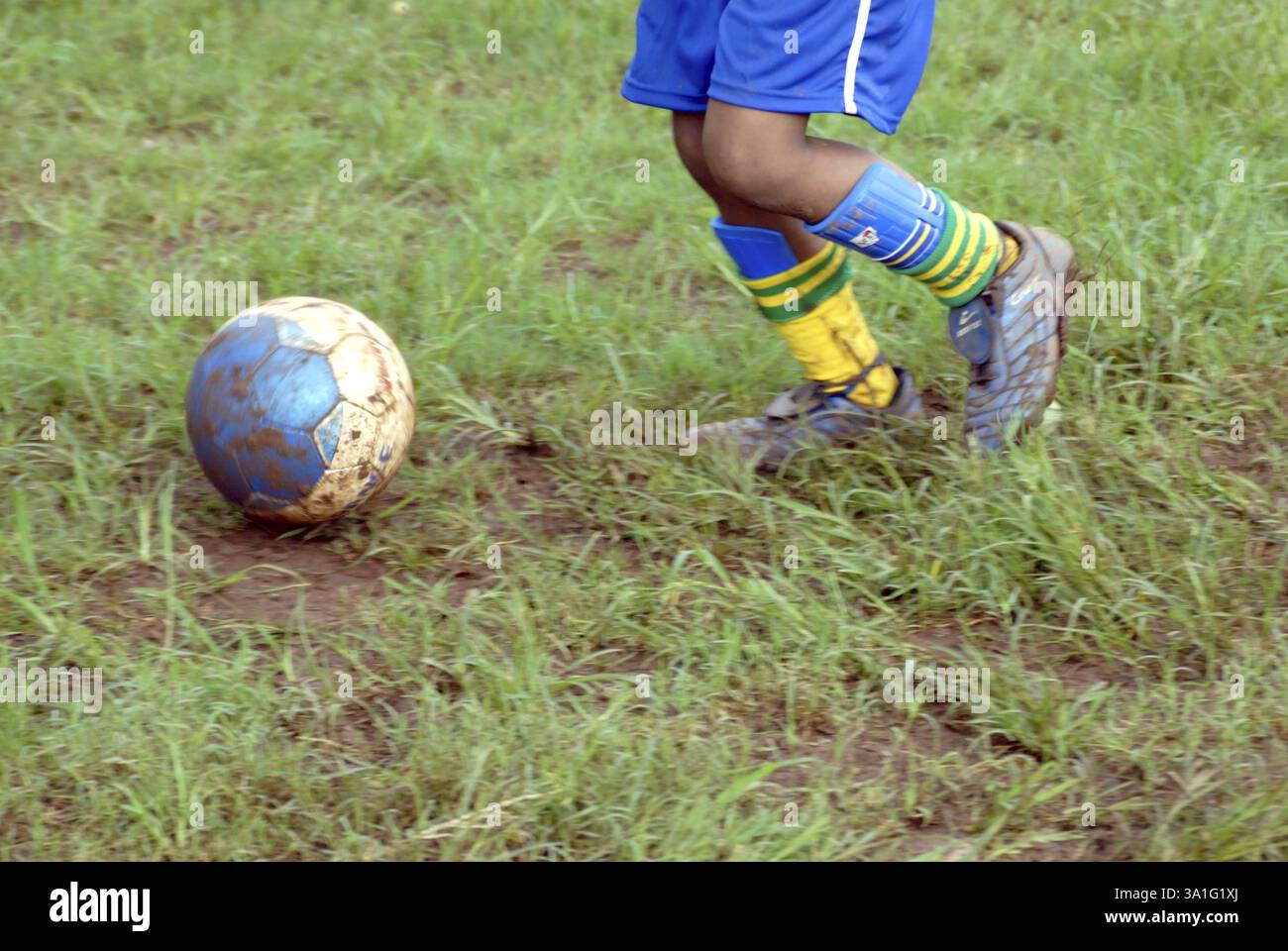 South Asian Indian boy playing, practice, enjoying with foot ball ...
