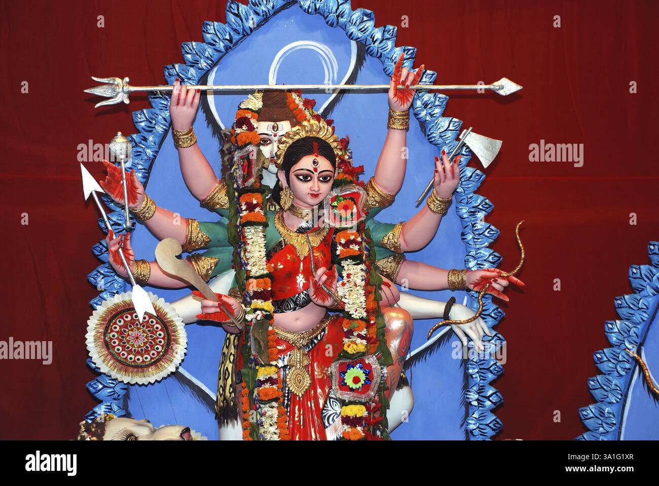 Durga clay model holding weapons and god shiva in background on Durga ...