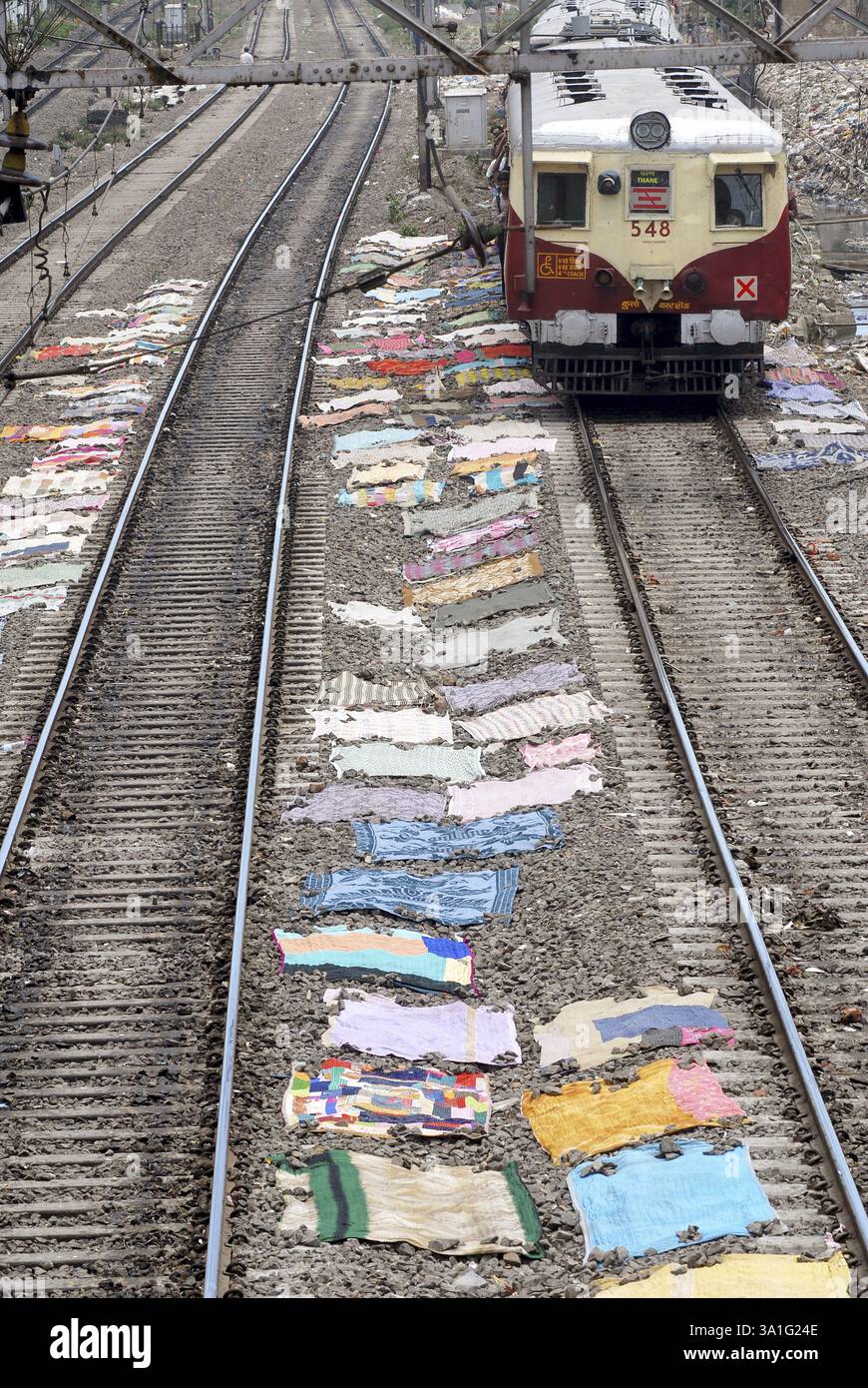 Washer men wash clothes in dirty waters and dry them on railway tracks ...