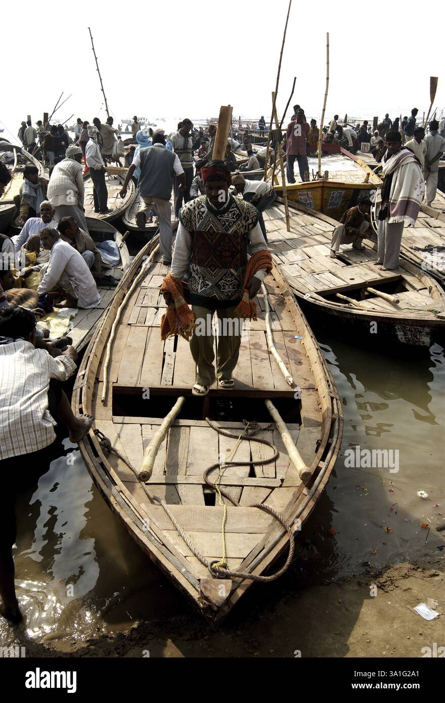 Boats or ferries ferry devotees at the confluence of the Ganges, Yamuna ...