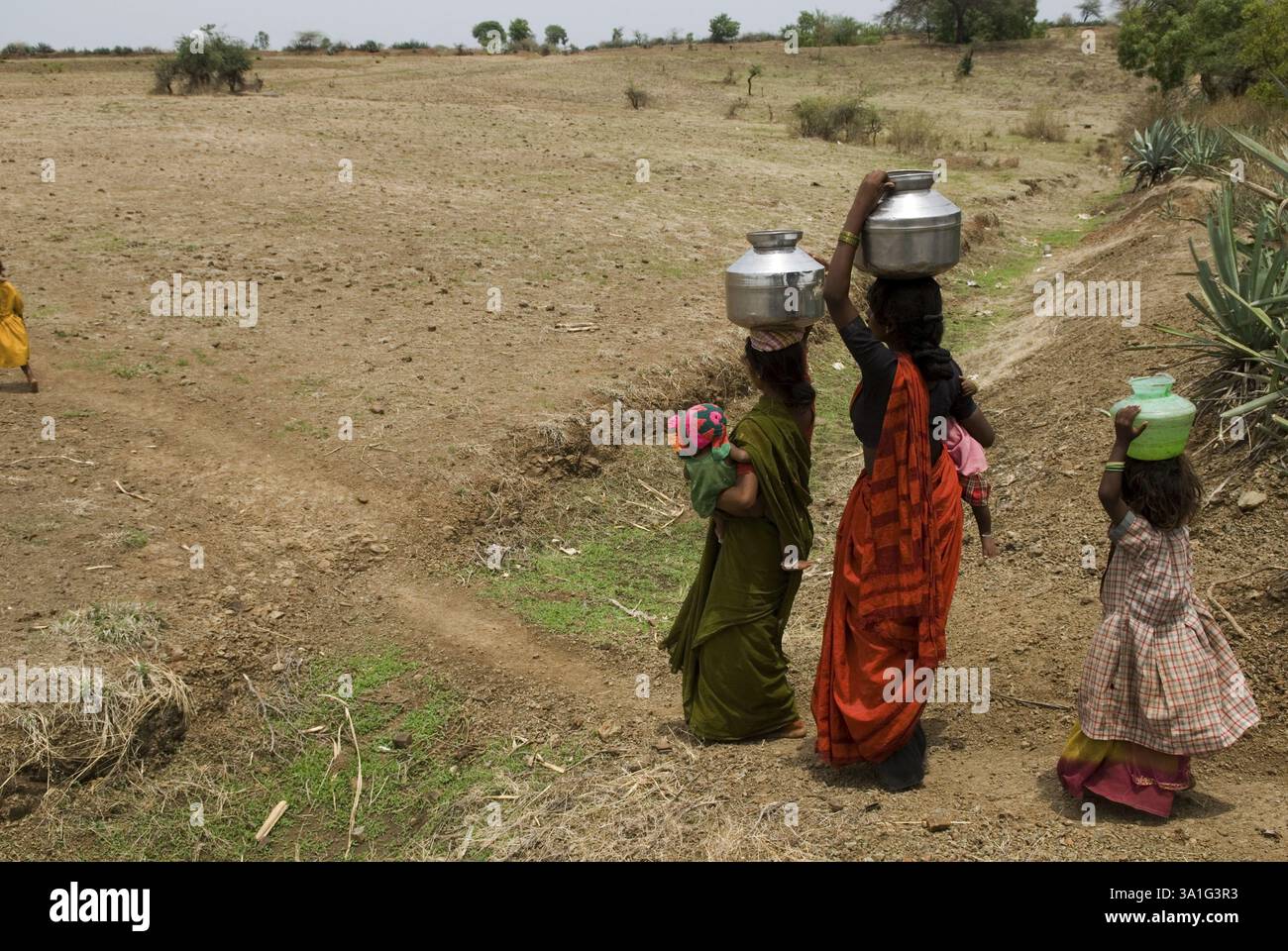 Water shortage Problem, women carrying water in pots from long distance ...