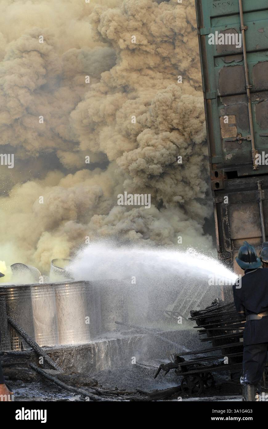Fire brigade personnel or fire fighters trying to extinguish fire in ...