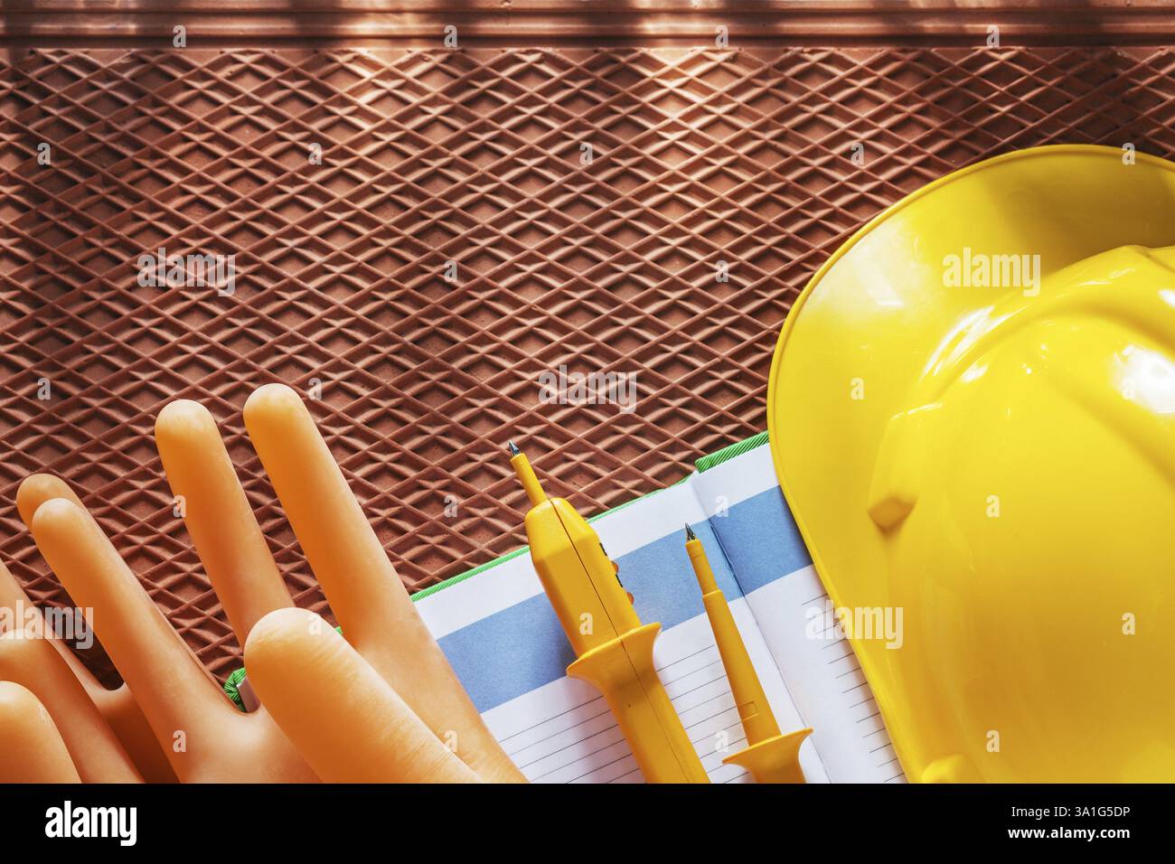 Notepad building helmet insulating gloves electrical tester on ...