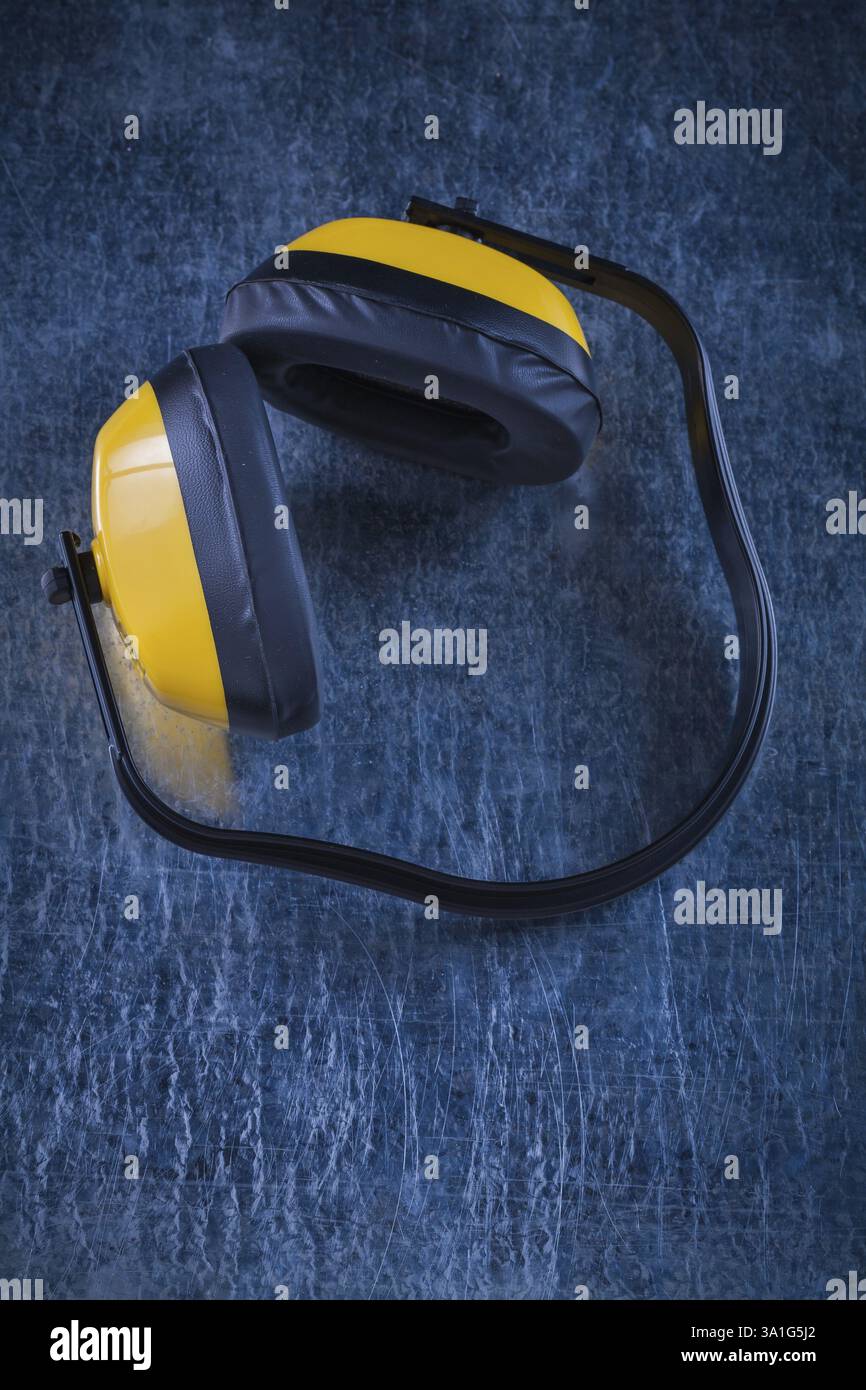 Noise reduction over-the-ear earmuffs on metallic surface construction ...