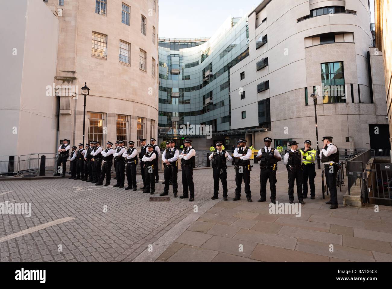 London, UK. 8 March, 2025. A row of police officers stand outside the ...
