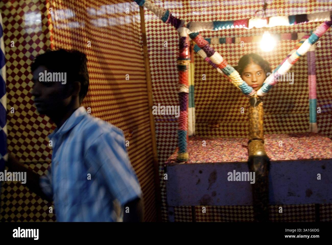 An attendant parts curtain to reveal illusionist's apparently ...