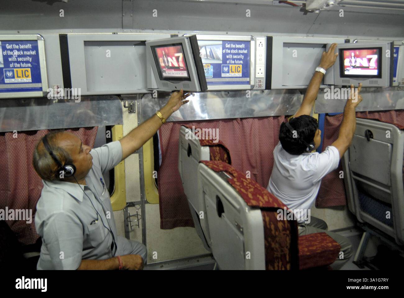 Passenger watching television introduce by Indian Railways on experimental basis in one of air ...
