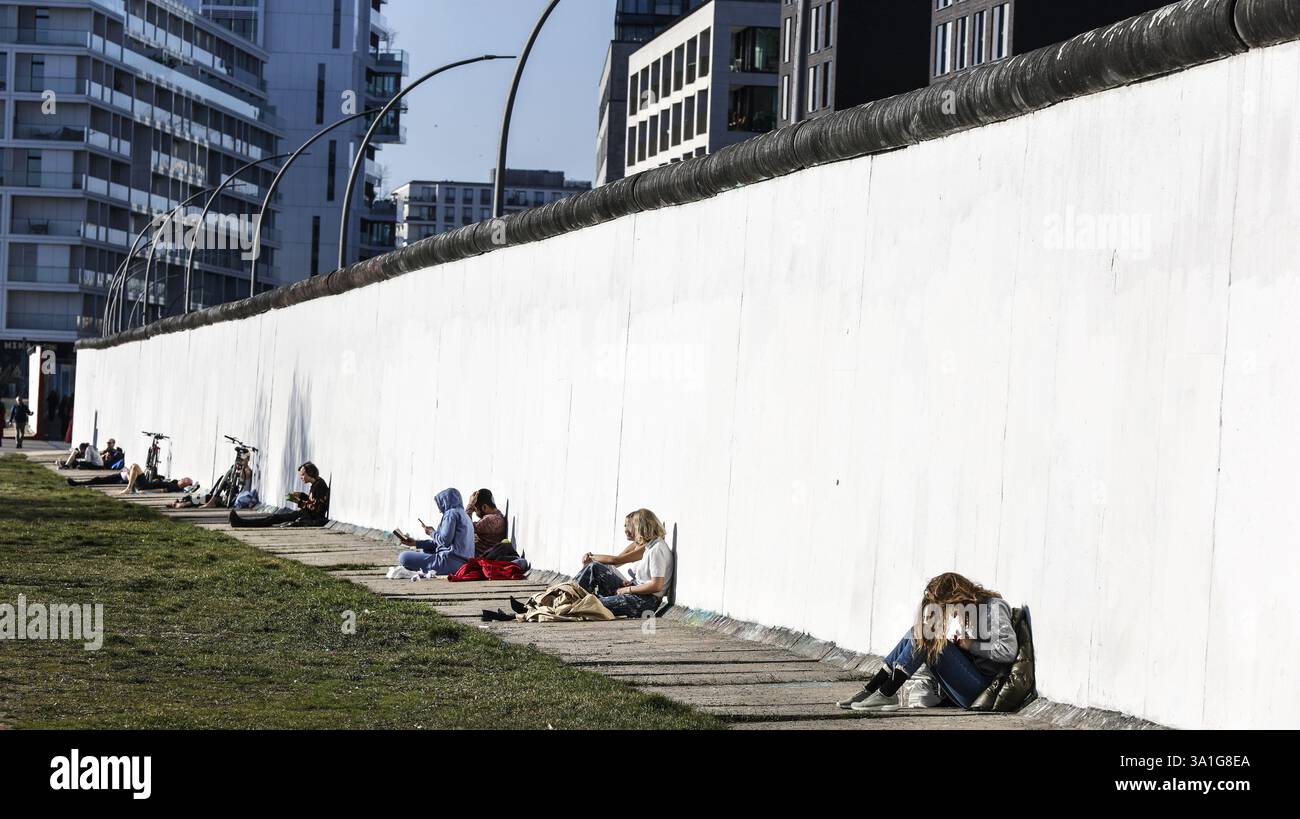 Visitors enjoy the first rays of spring sunshine at the East Side ...