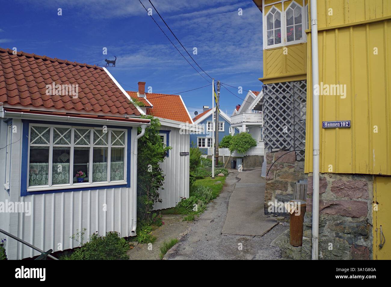 Narrow alley with colourful wooden houses, quiet summer environment, idyll, crystal clear water ...